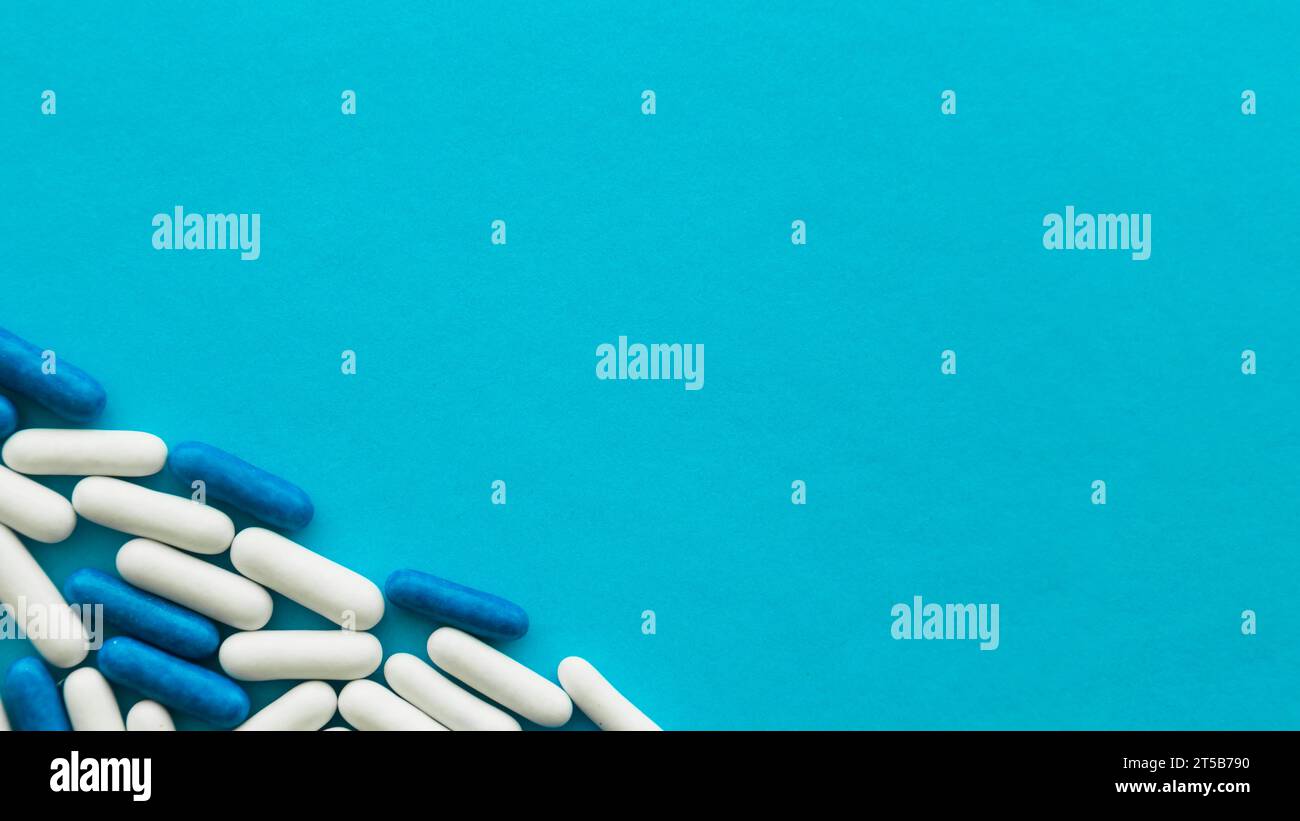 Elevated view white blue candy capsules corner cyan backdrop Stock ...