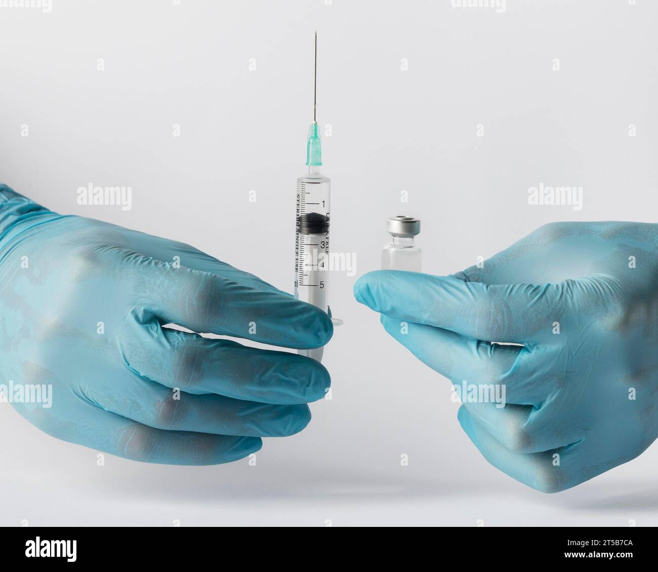Front view doctor putting vaccine syringe Stock Photo - Alamy