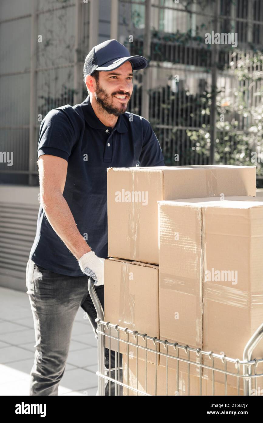 Man walking with boxes hi-res stock photography and images - Alamy