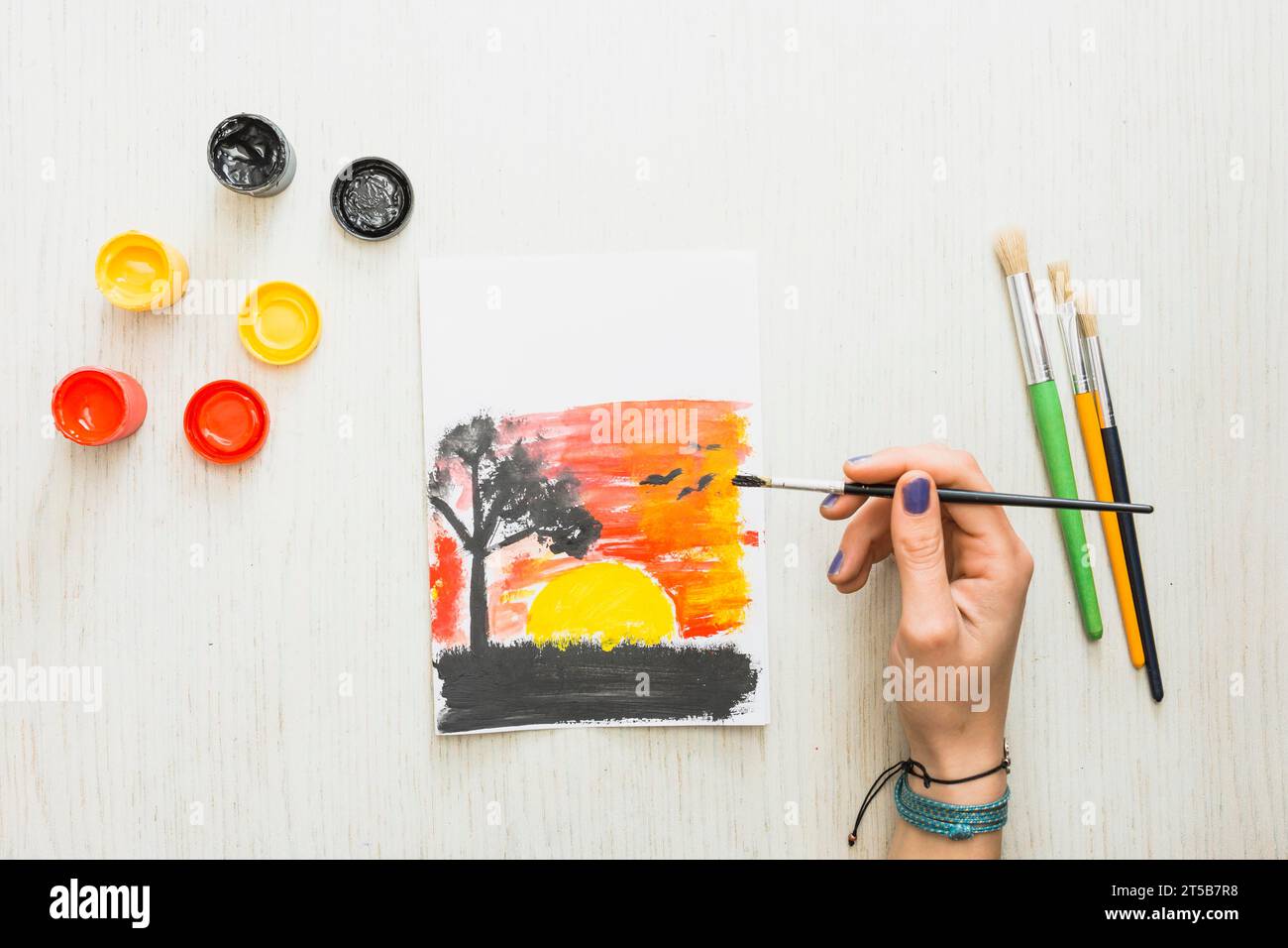 Human hand painting beautiful nature sunset seen paper with water ...