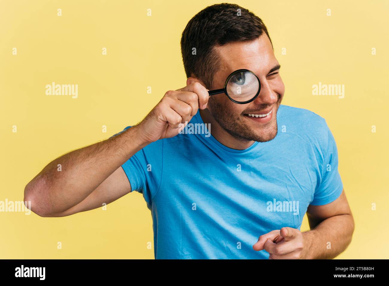 Man watching through magnifier Stock Photo - Alamy