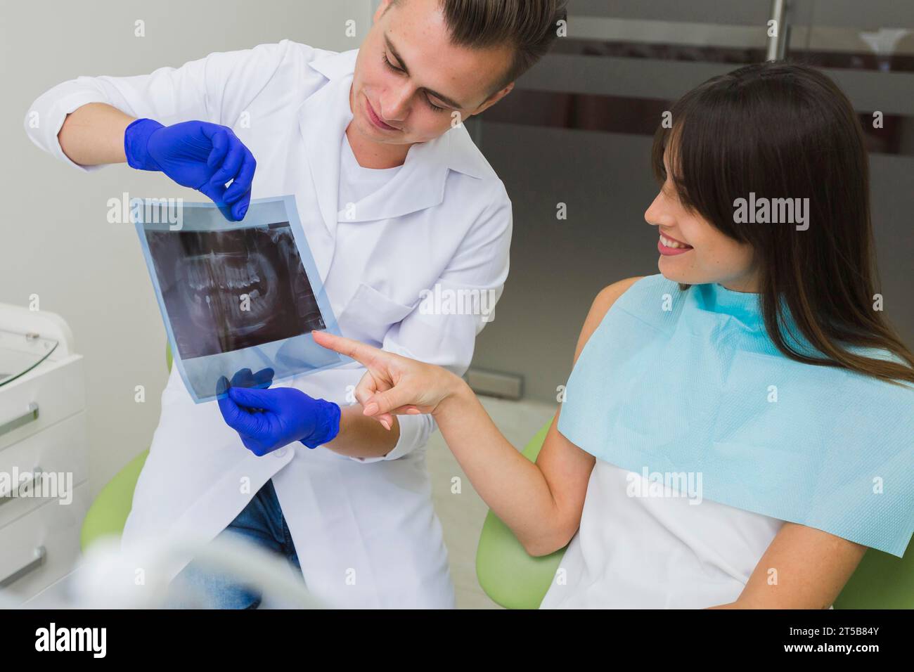 Patient pointing radiography dentist Stock Photo - Alamy