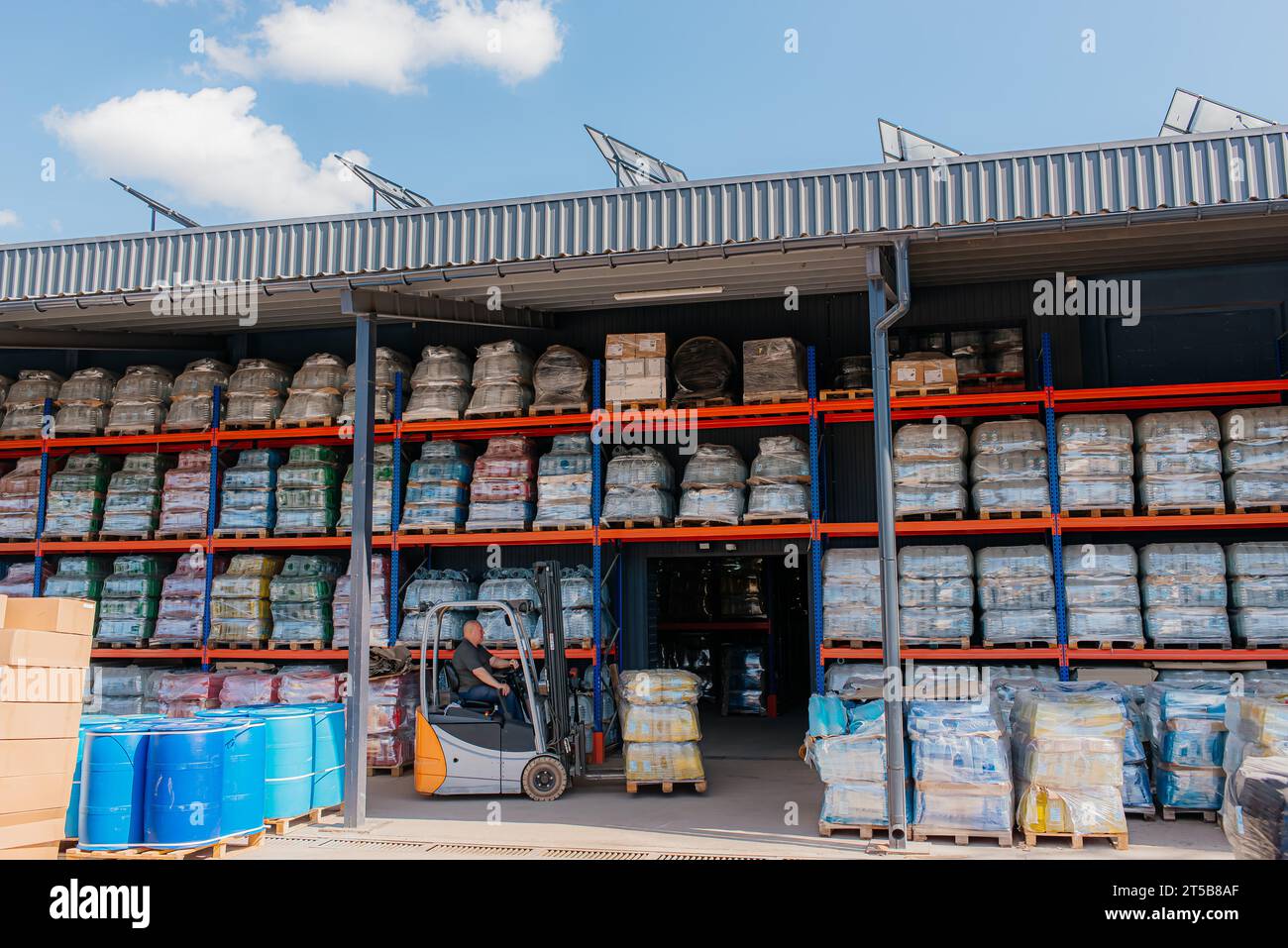 Warehouse man worker with forklift Stock Photo - Alamy