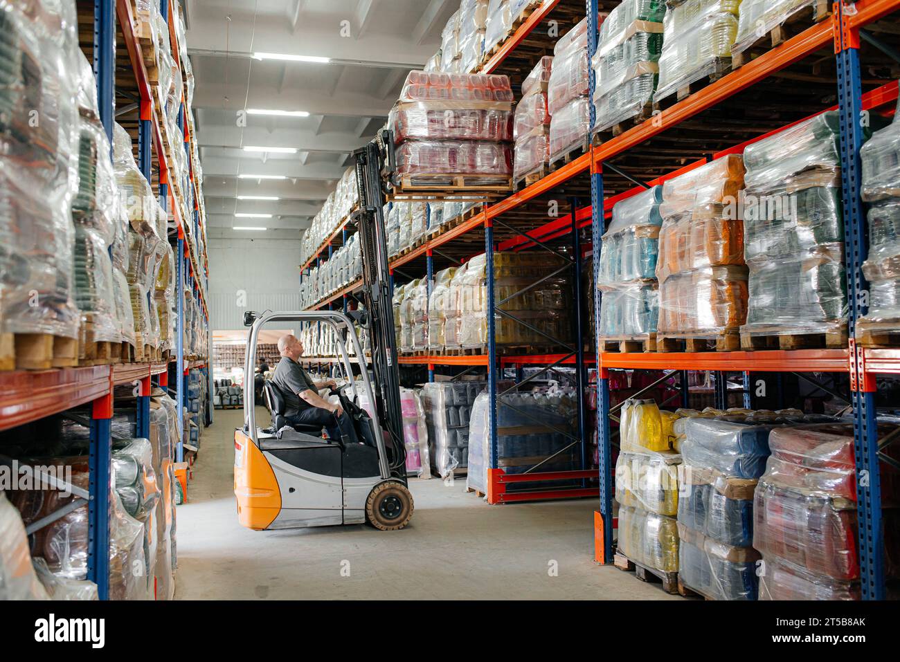 Warehouse man worker with forklift Stock Photo - Alamy