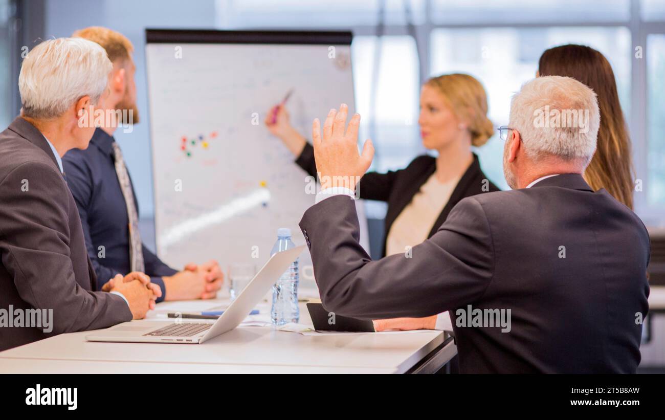 Asking questions during presentation hi-res stock photography and ...