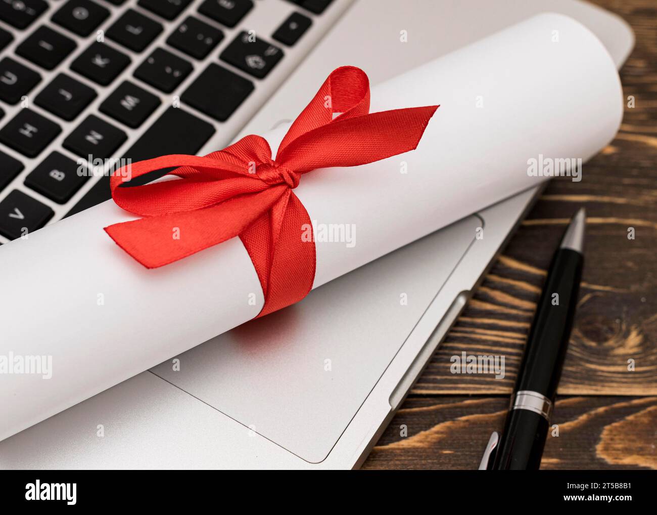 Rolled graduation diploma certificate Stock Photo - Alamy