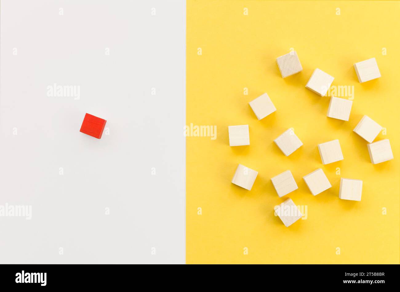 Red cube separated from group wooden ones Stock Photo - Alamy