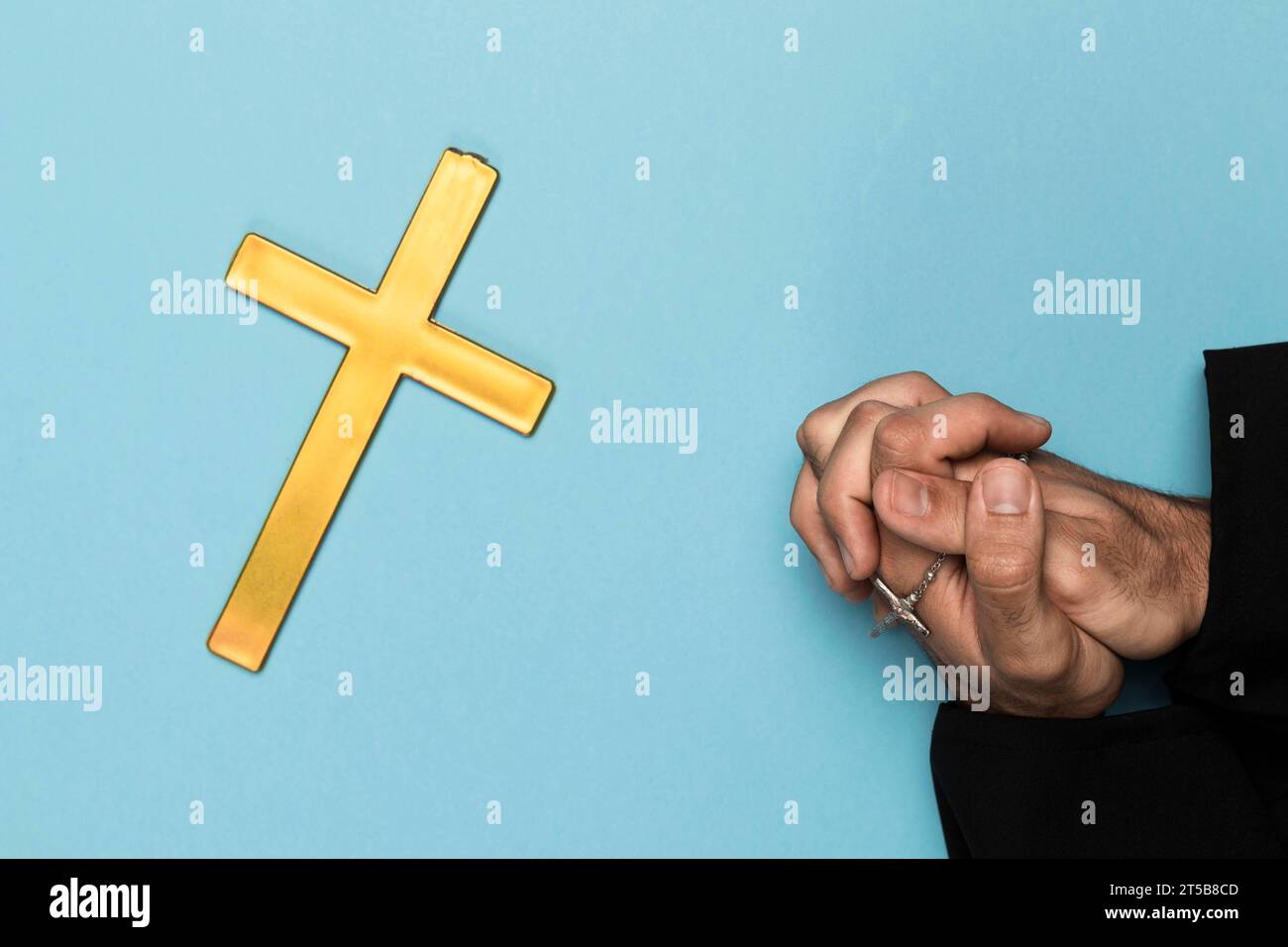 Priest praying with wood cross Stock Photo - Alamy