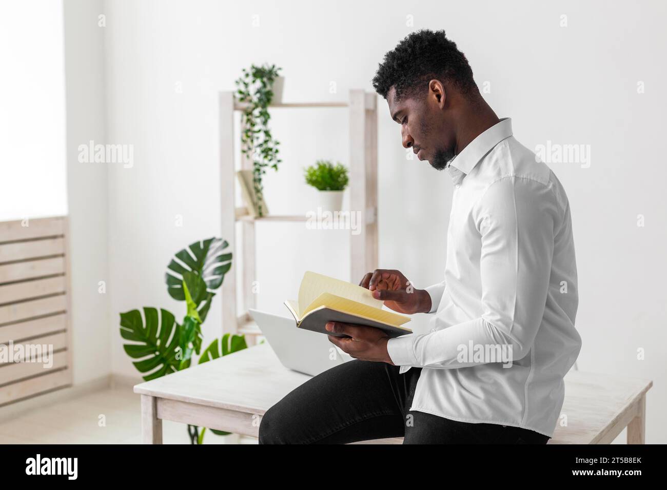 Side view african american man reading Stock Photo - Alamy