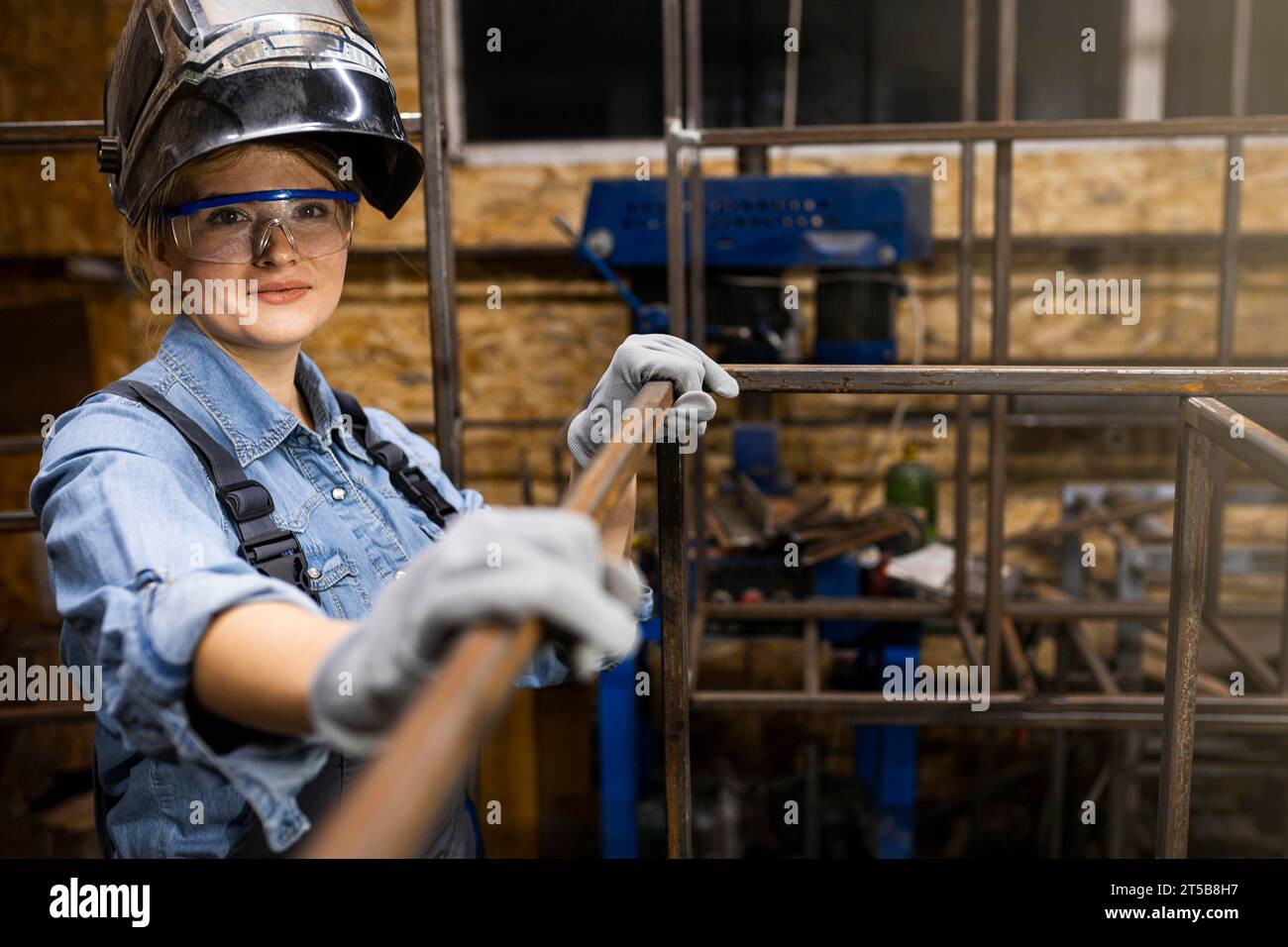 Smiley female welder work Stock Photo - Alamy