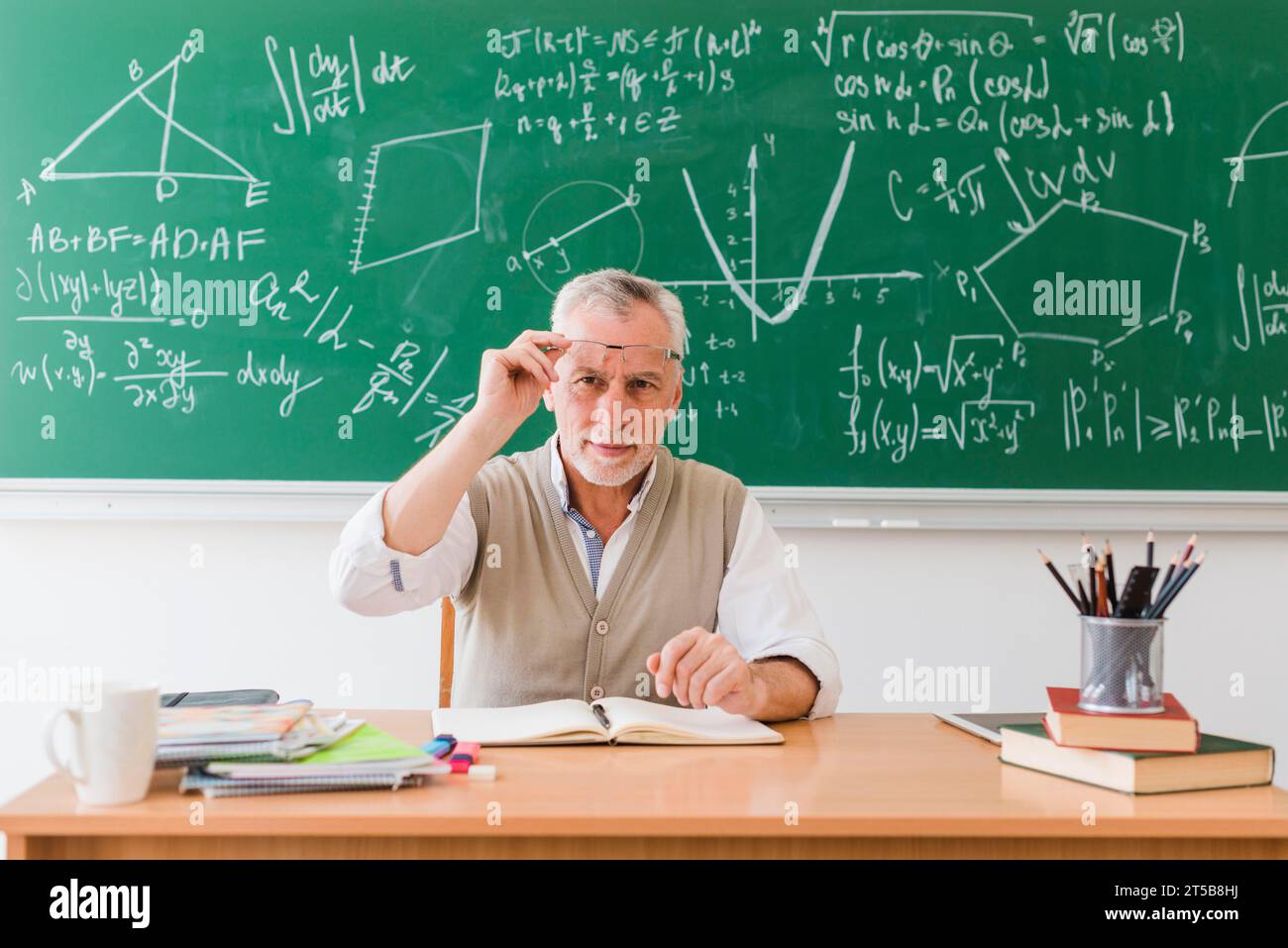 Smiling old professor maths classroom Stock Photo - Alamy