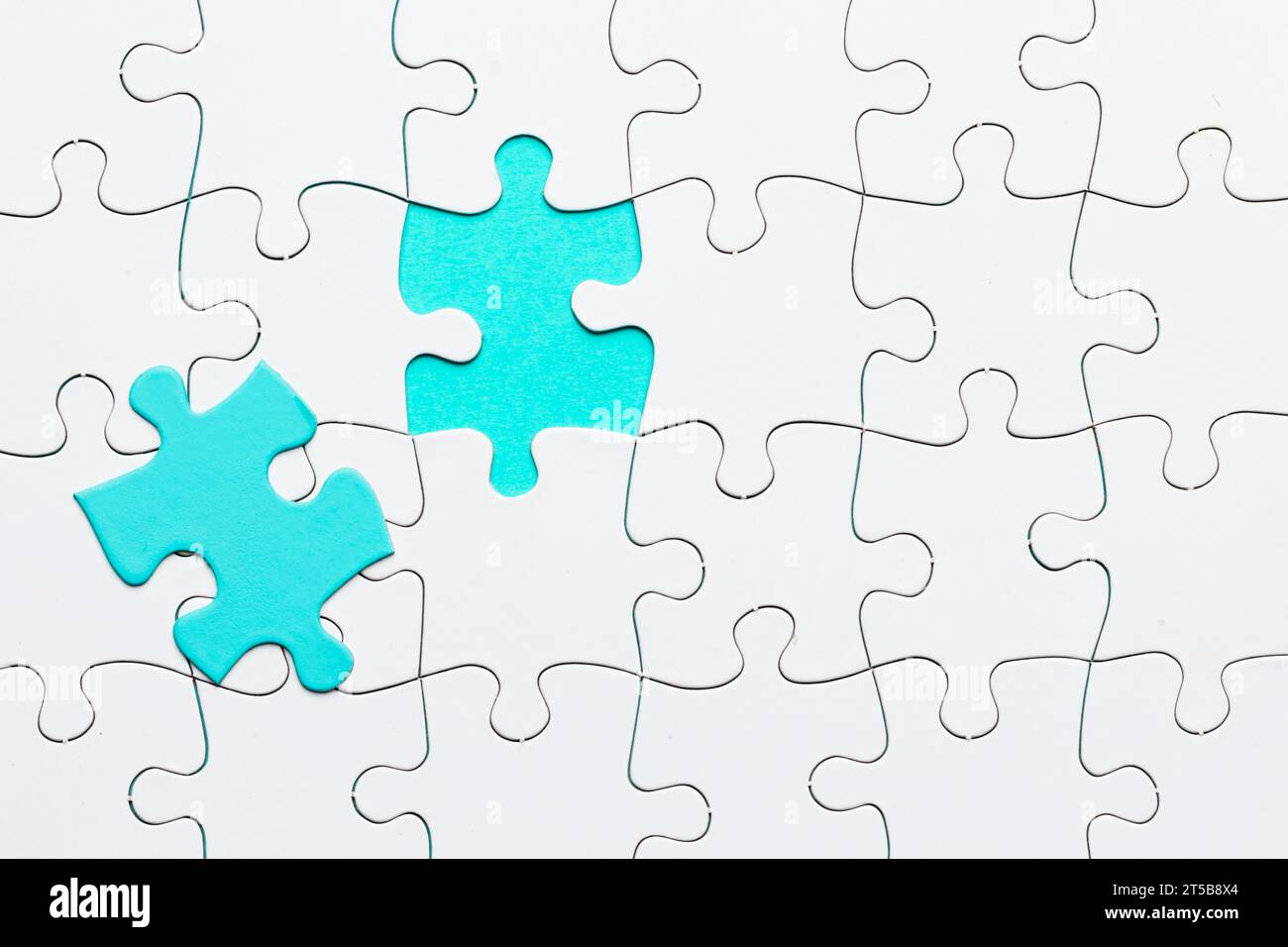 Turquoise piece puzzle white jigsaw puzzle backdrop Stock Photo - Alamy