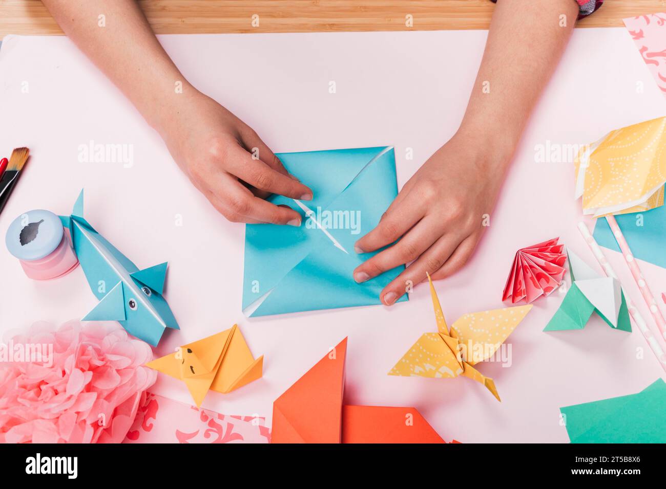 Top view woman hand making origami craft table Stock Photo - Alamy
