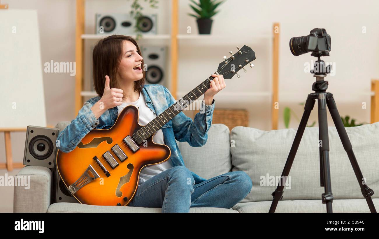 Woman filming music video home Stock Photo - Alamy