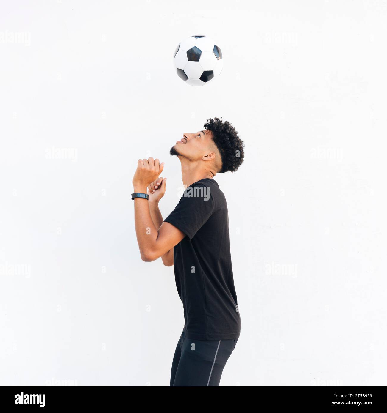 Young black man juggling soccer ball Stock Photo - Alamy