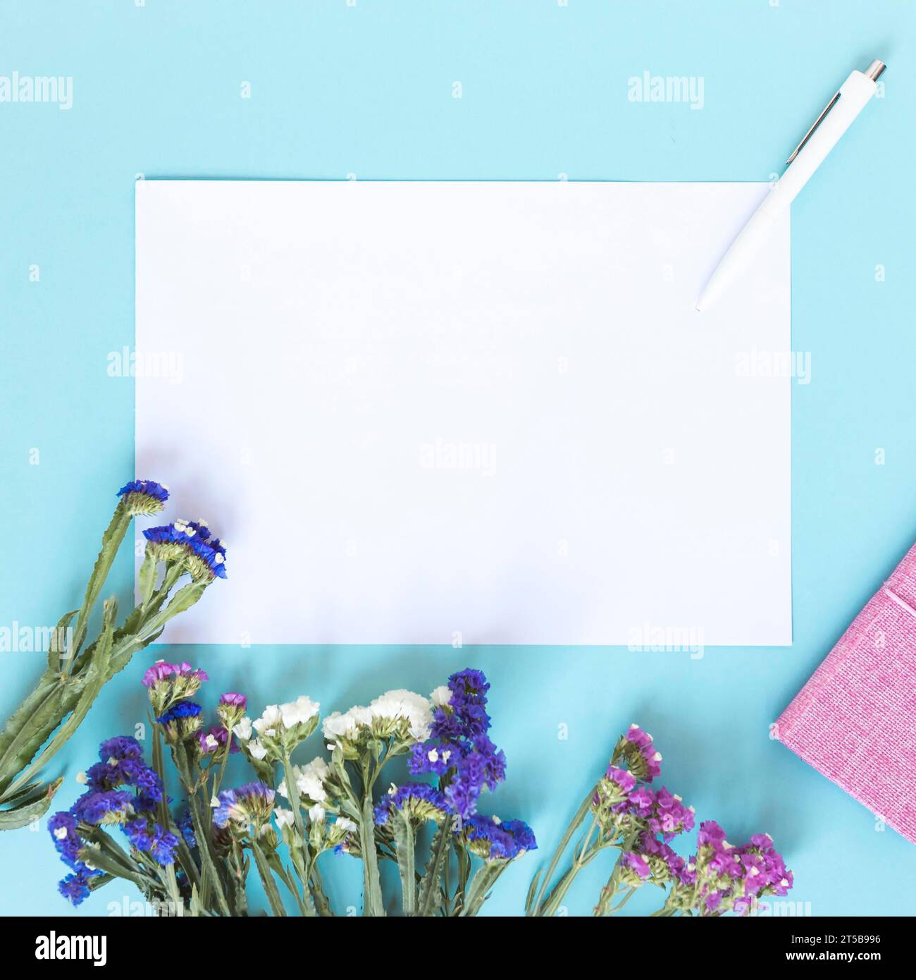 Blank paper sheet pen bunch colorful flowers blue backdrop Stock Photo ...