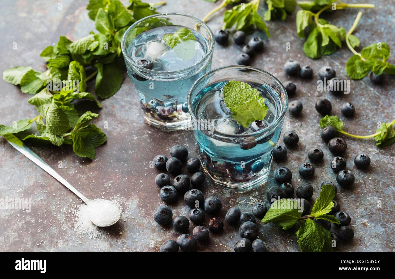 Berries mint around refreshing blueberry drinks Stock Photo - Alamy