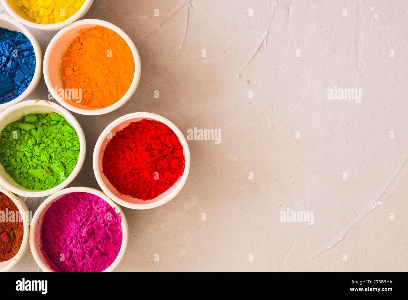 Bowls holi color powder concrete background Stock Photo - Alamy