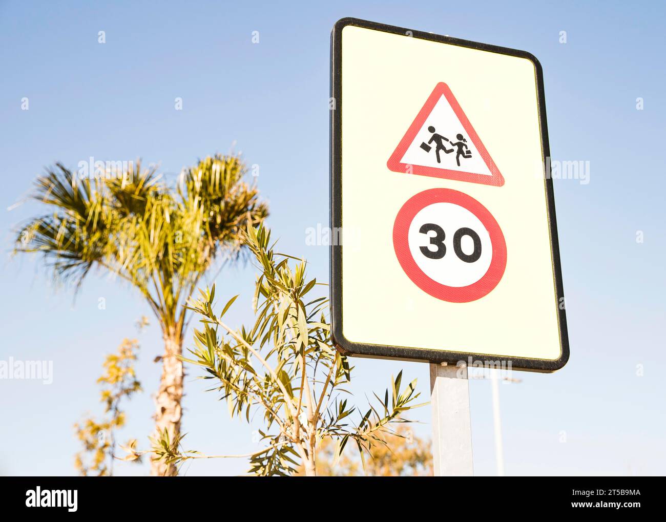 Close up pedestrians warning sign with 30 speed limit sign against ...