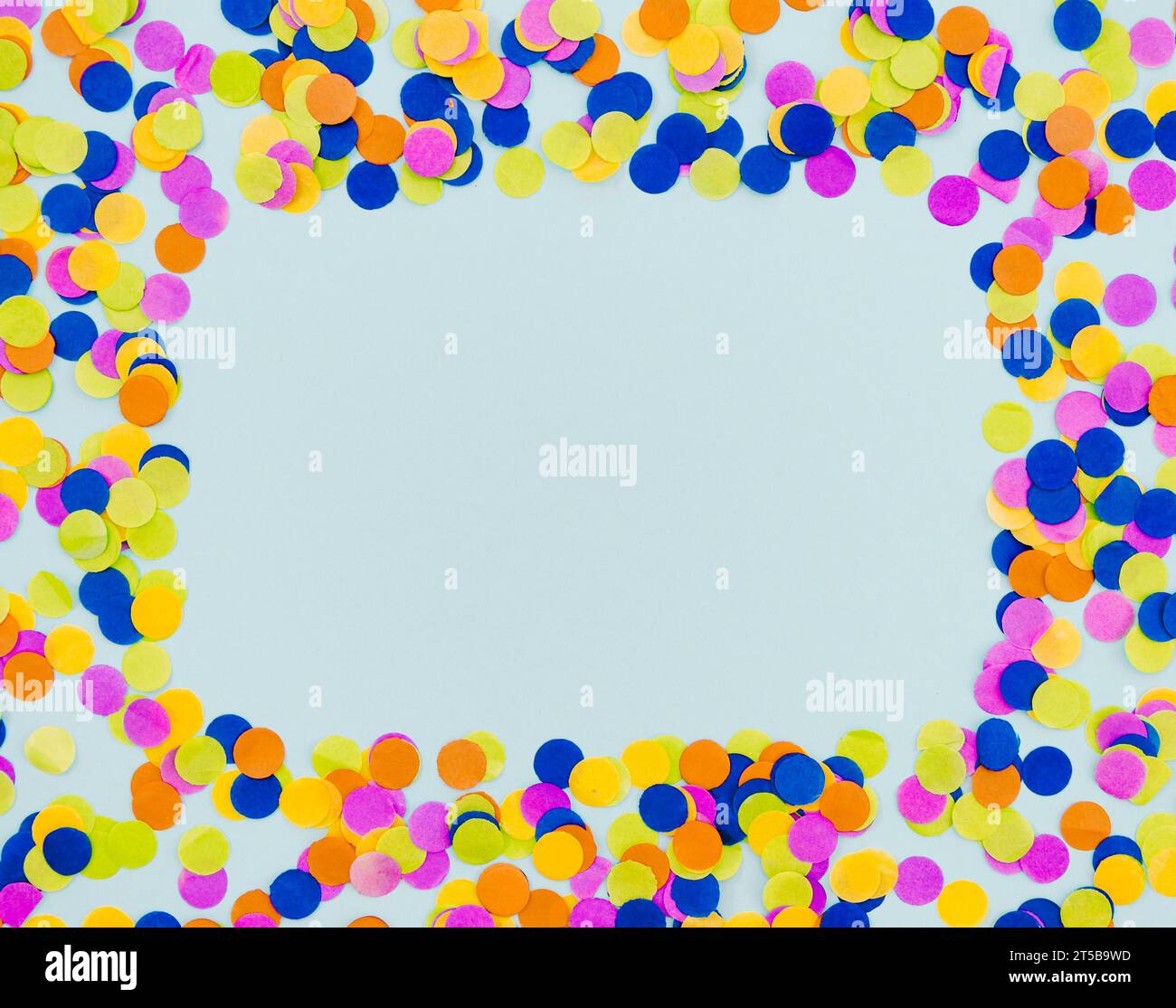 Colourful confetti frame blue background Stock Photo - Alamy