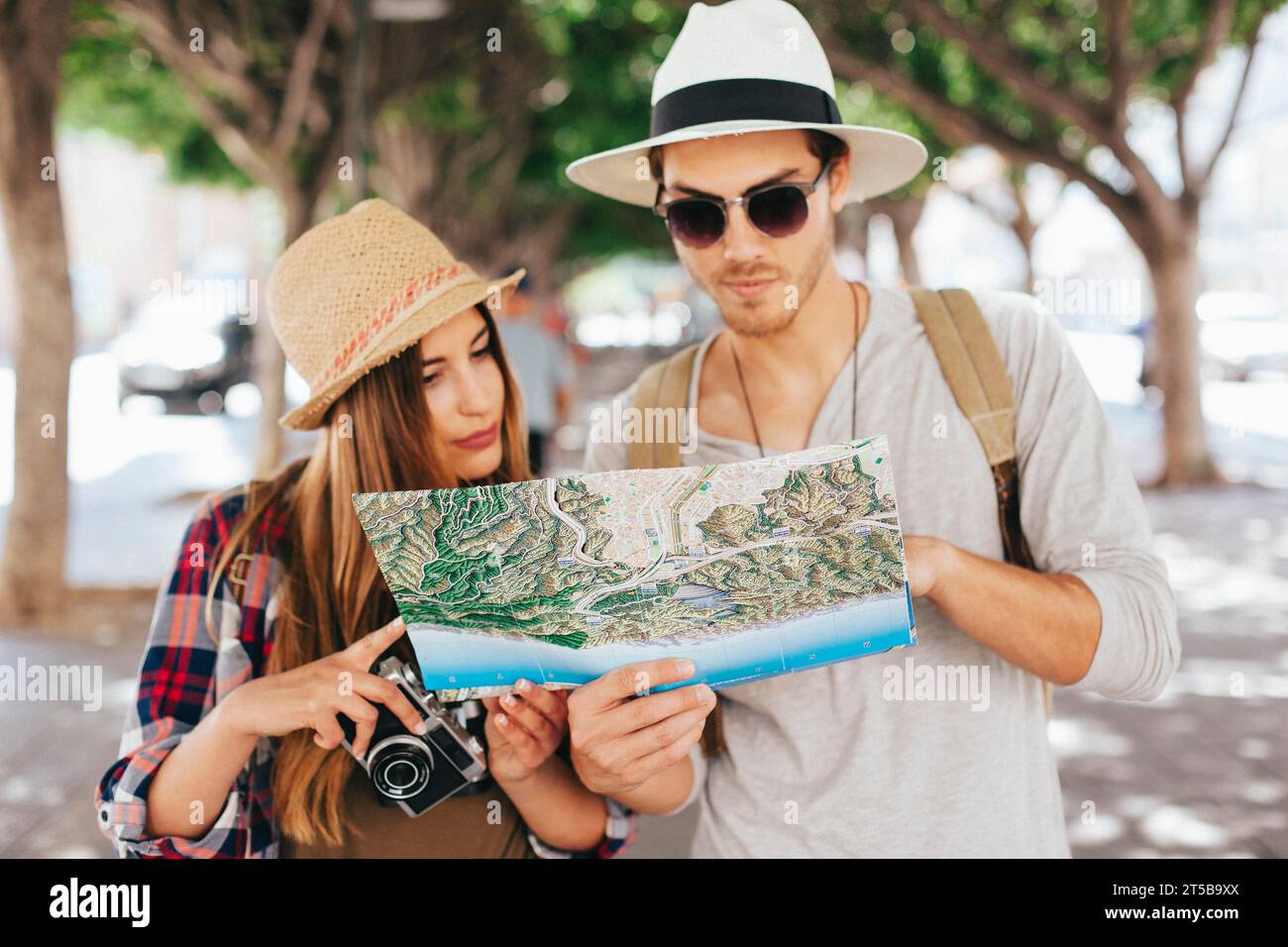 Couple tourists map Stock Photo - Alamy
