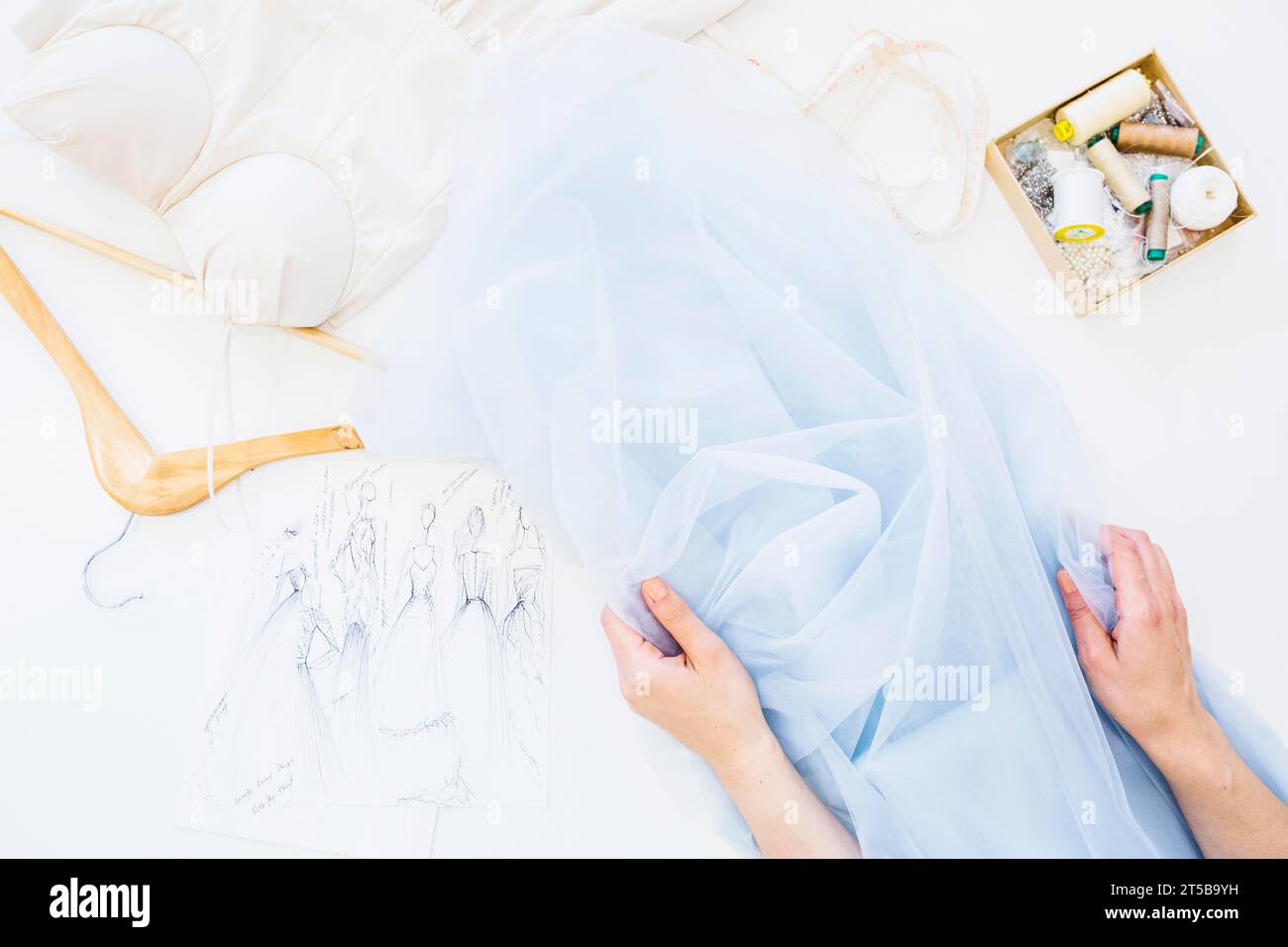 Designer s hand with textile workbench Stock Photo - Alamy