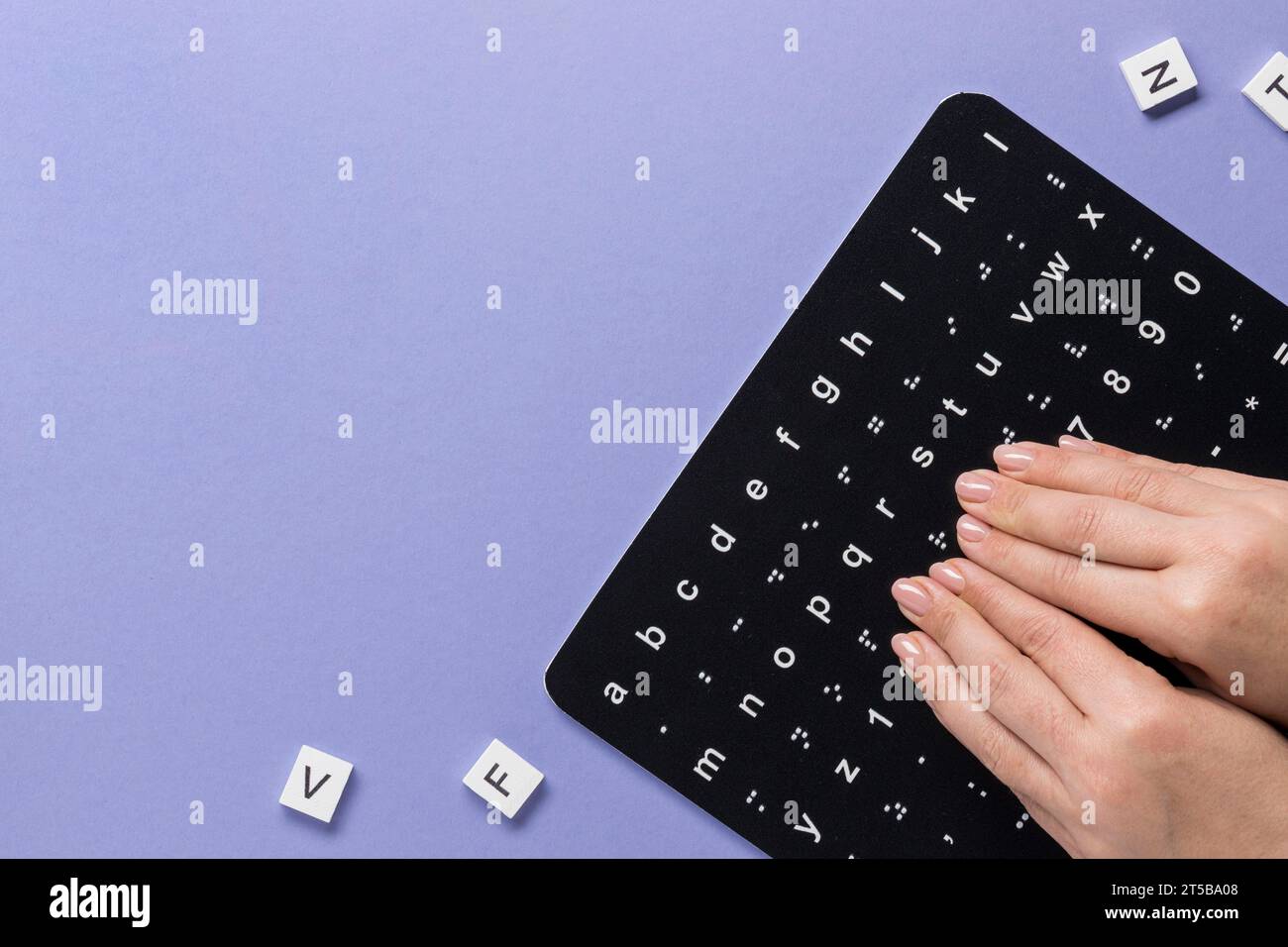 Fingers touching braille alphabet board top view Stock Photo - Alamy