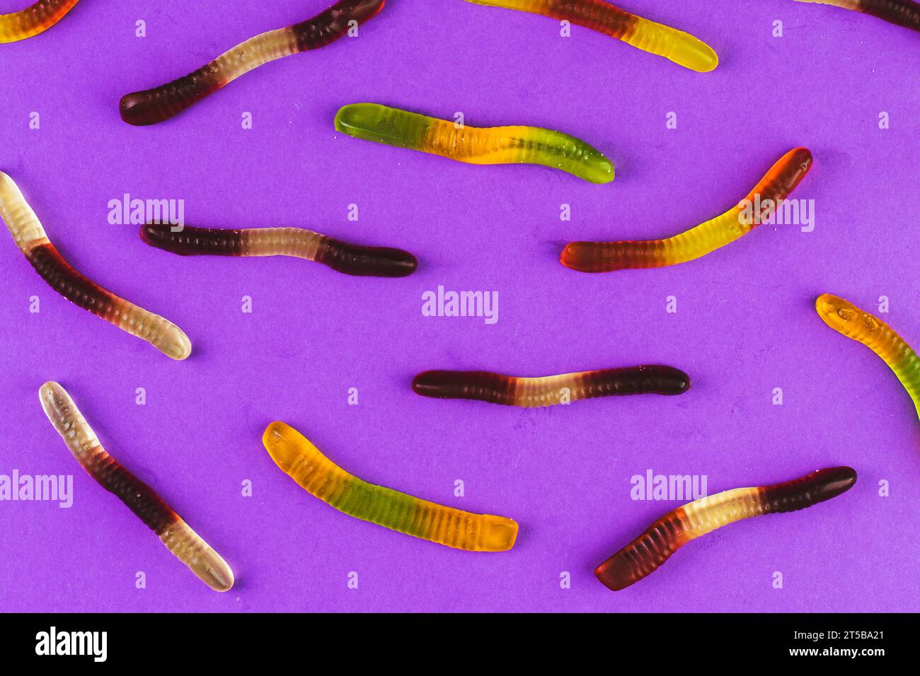 Elevated view jelly worms purple background Stock Photo - Alamy