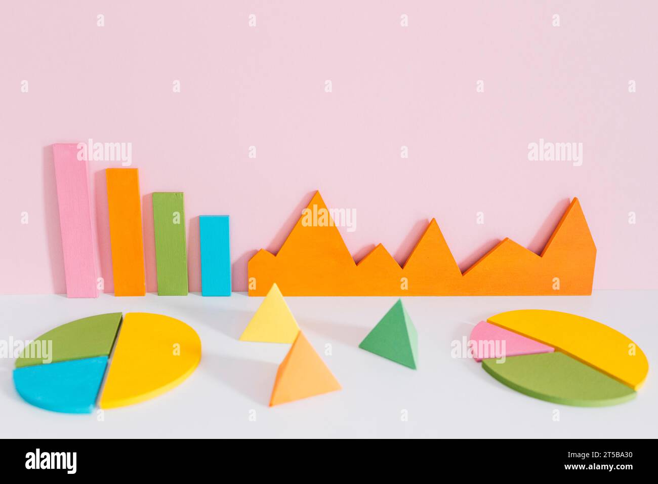 Different colorful graph with pyramid shapes against pink background ...