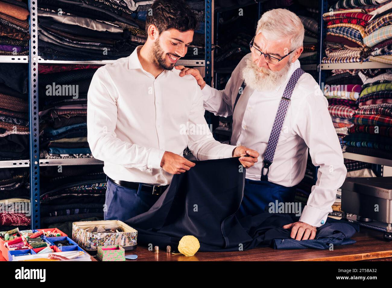 Fashion designer customer looking fabric his shop Stock Photo - Alamy