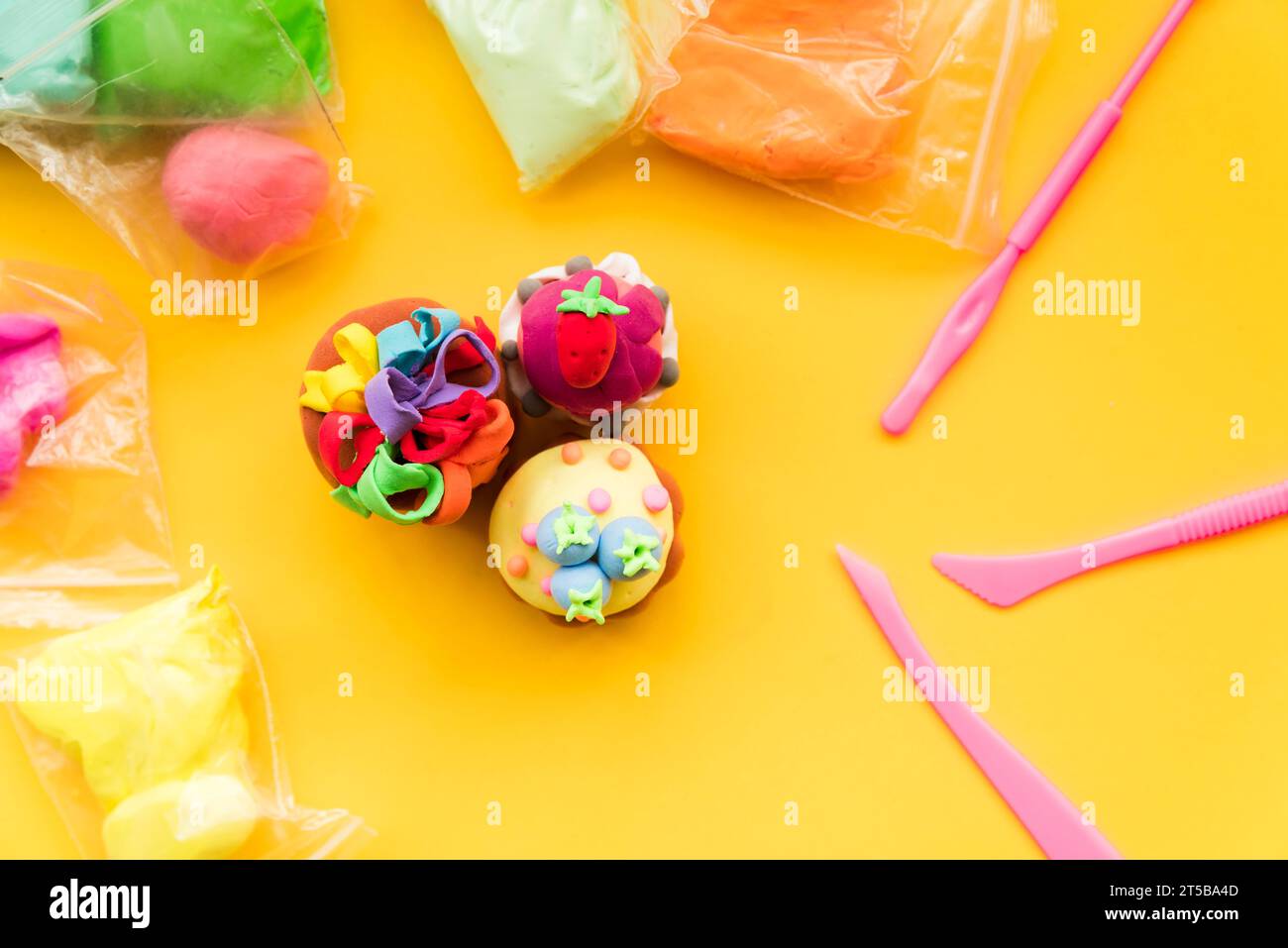 Different type handmade colorful clay yellow backdrop Stock Photo - Alamy