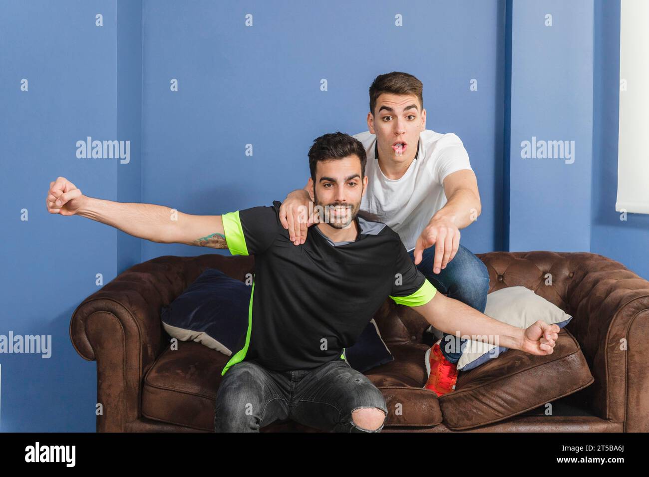 Football fans celebrating living room Stock Photo - Alamy