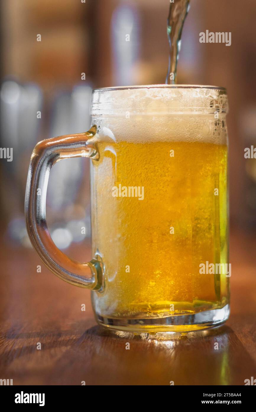 Front view foaming beer pint Stock Photo - Alamy