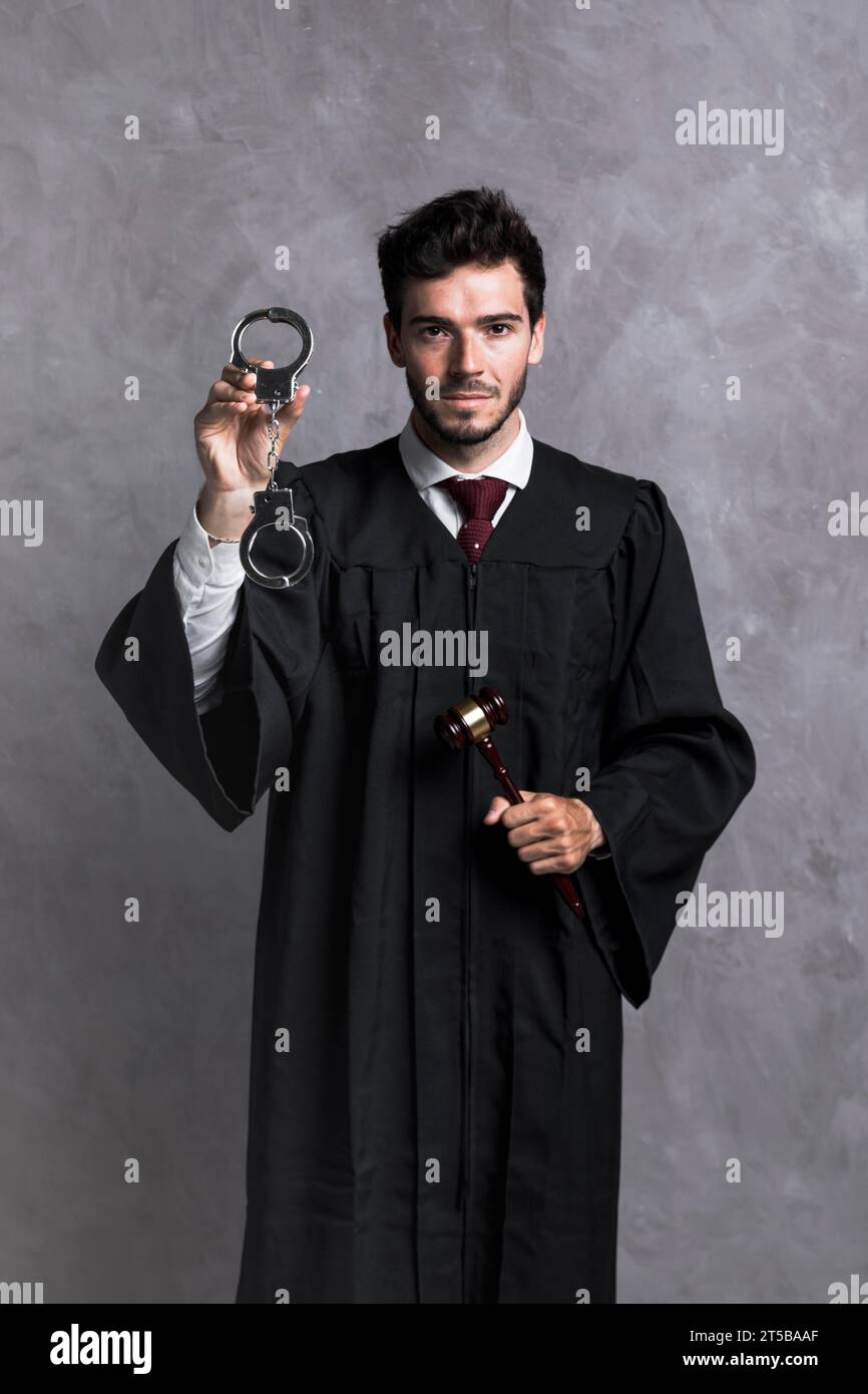 Front view judge robe with handcuffs gavel Stock Photo - Alamy