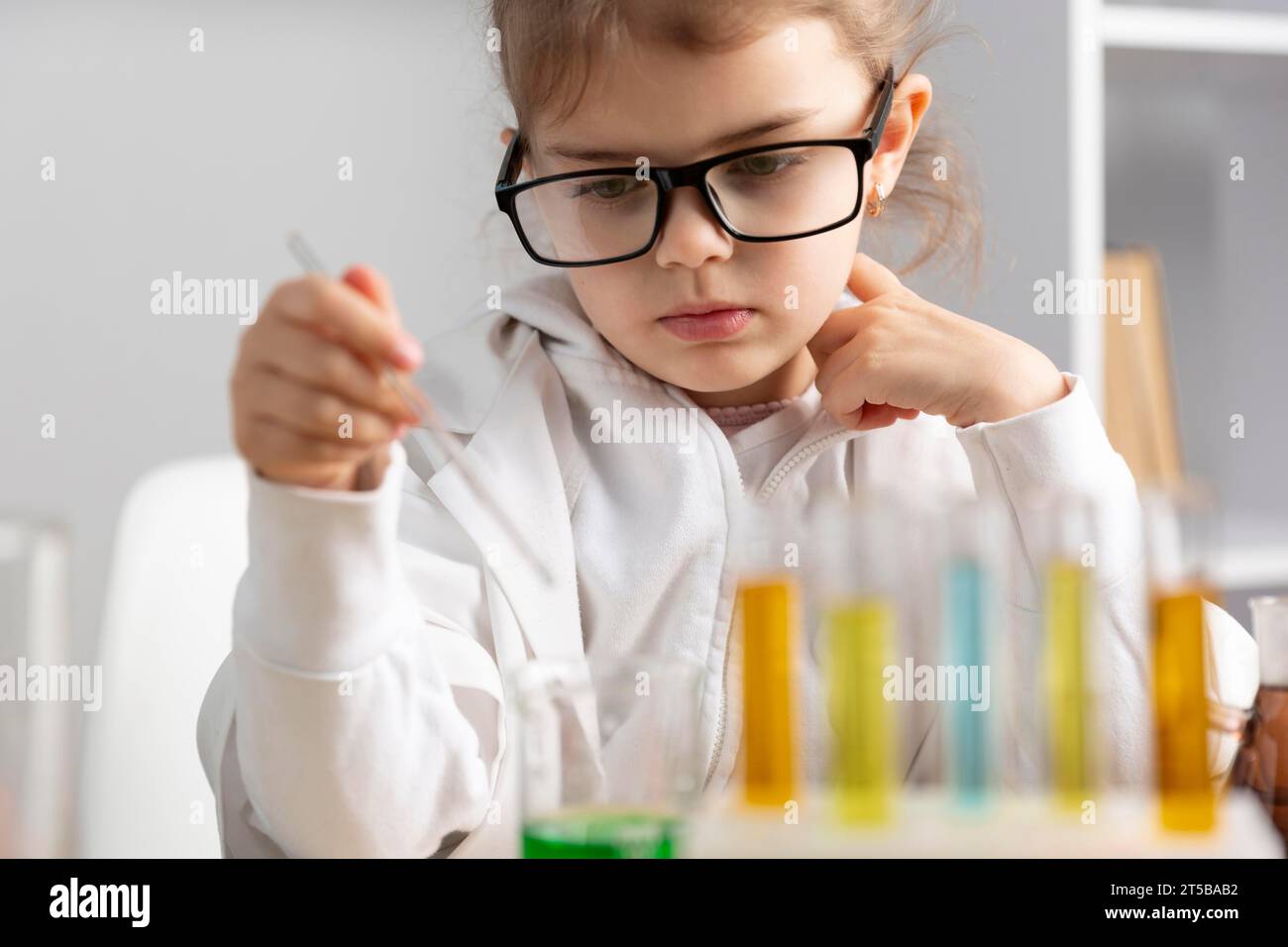 Girl doing experiments laboratory Stock Photo - Alamy