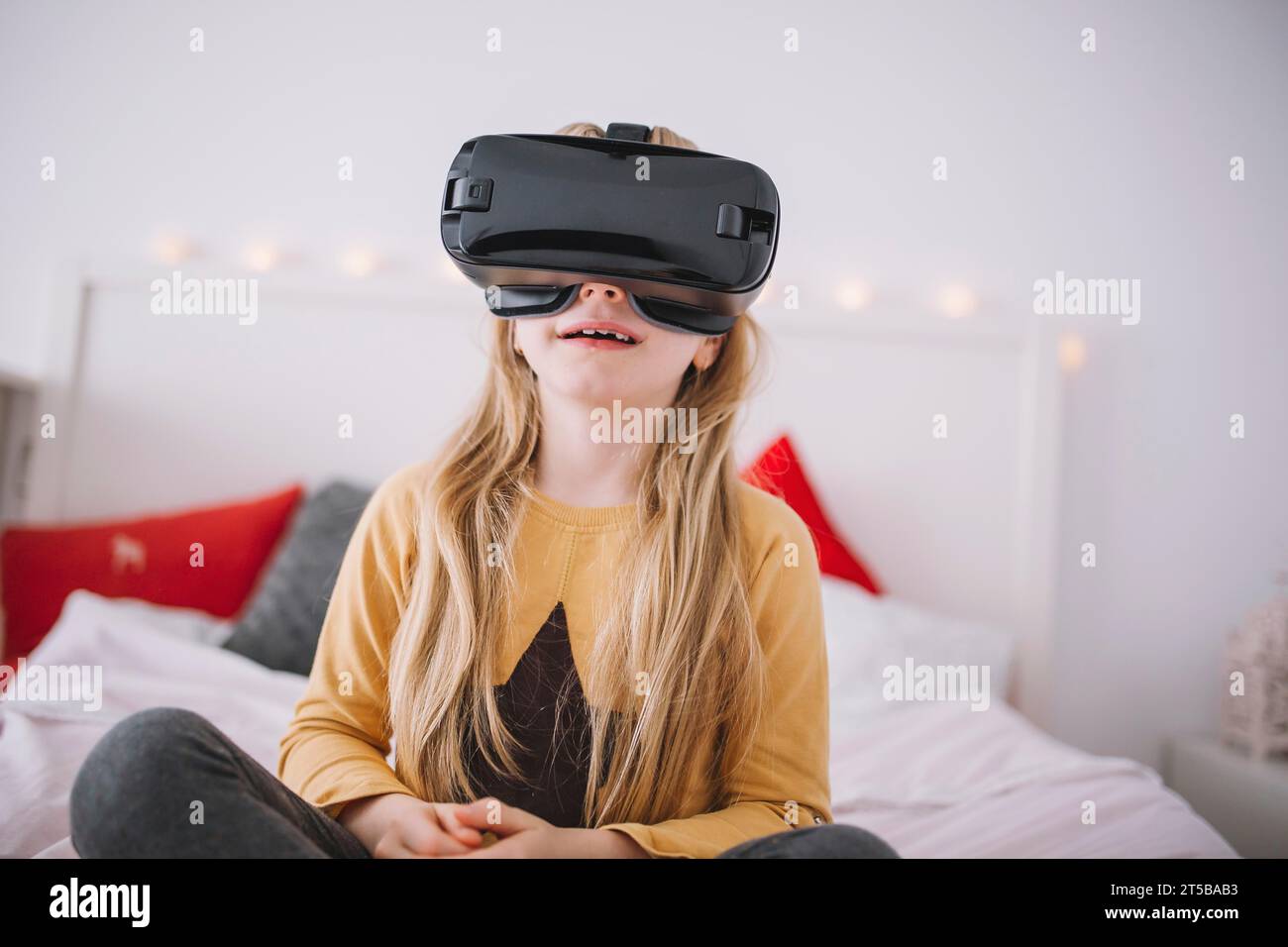 Girl vr goggles bed Stock Photo - Alamy