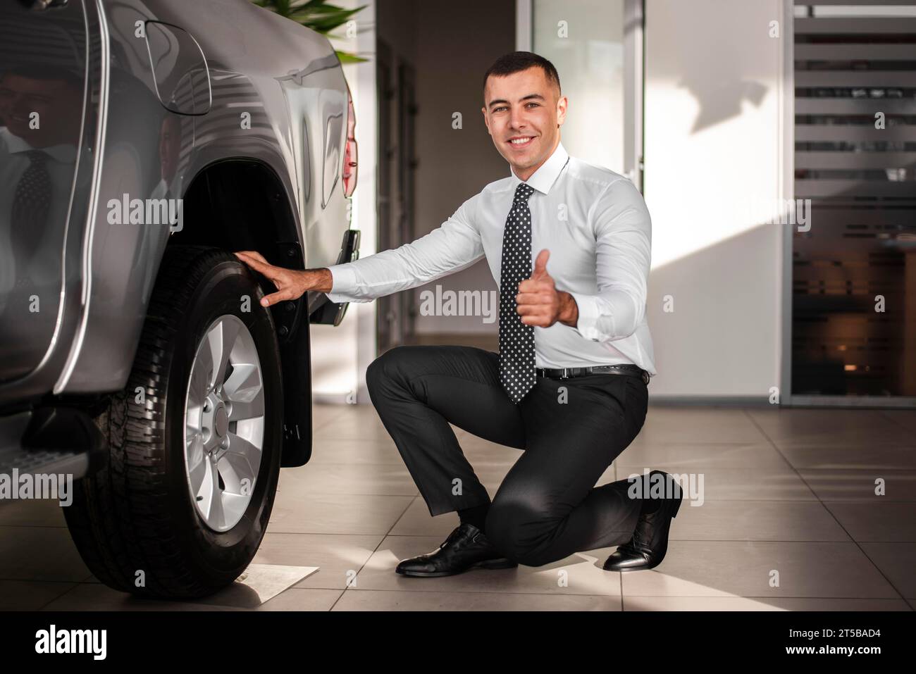 Front view man one knee showing ok sign Stock Photo - Alamy