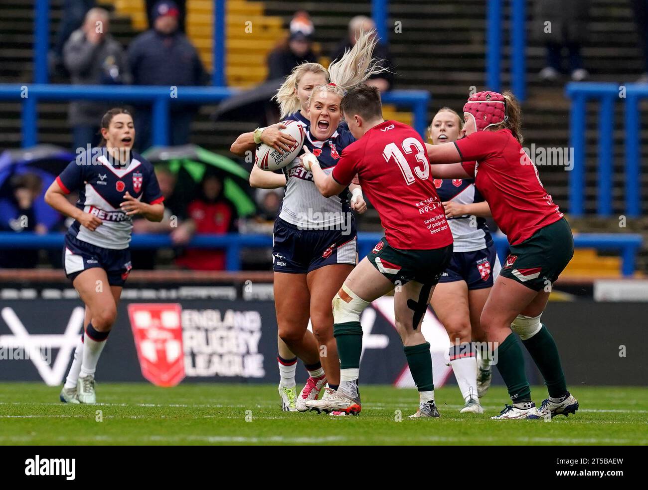 England's Amy Hardcastle (left) holds of tackled from Wales' Shaunni ...
