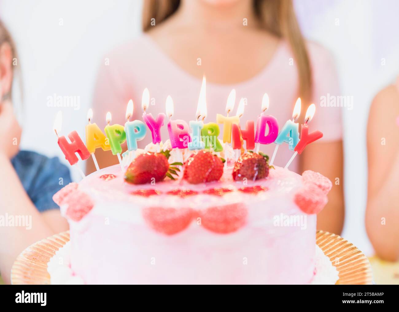 Close up colorful glowing birthday candles strawberry topping cake ...