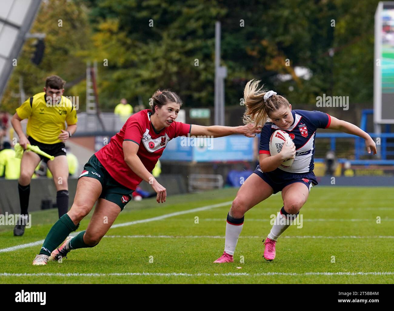 England's Eboni Partington (right) evades a tackle from Wales' Eleri ...