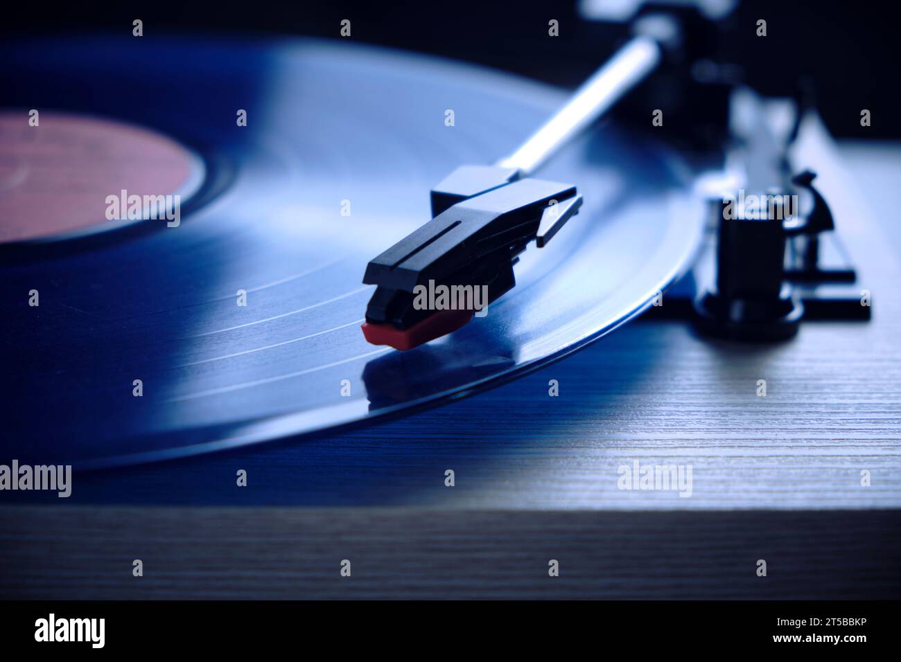 Classic vinyl record player closeup with contoured daylight from window ...