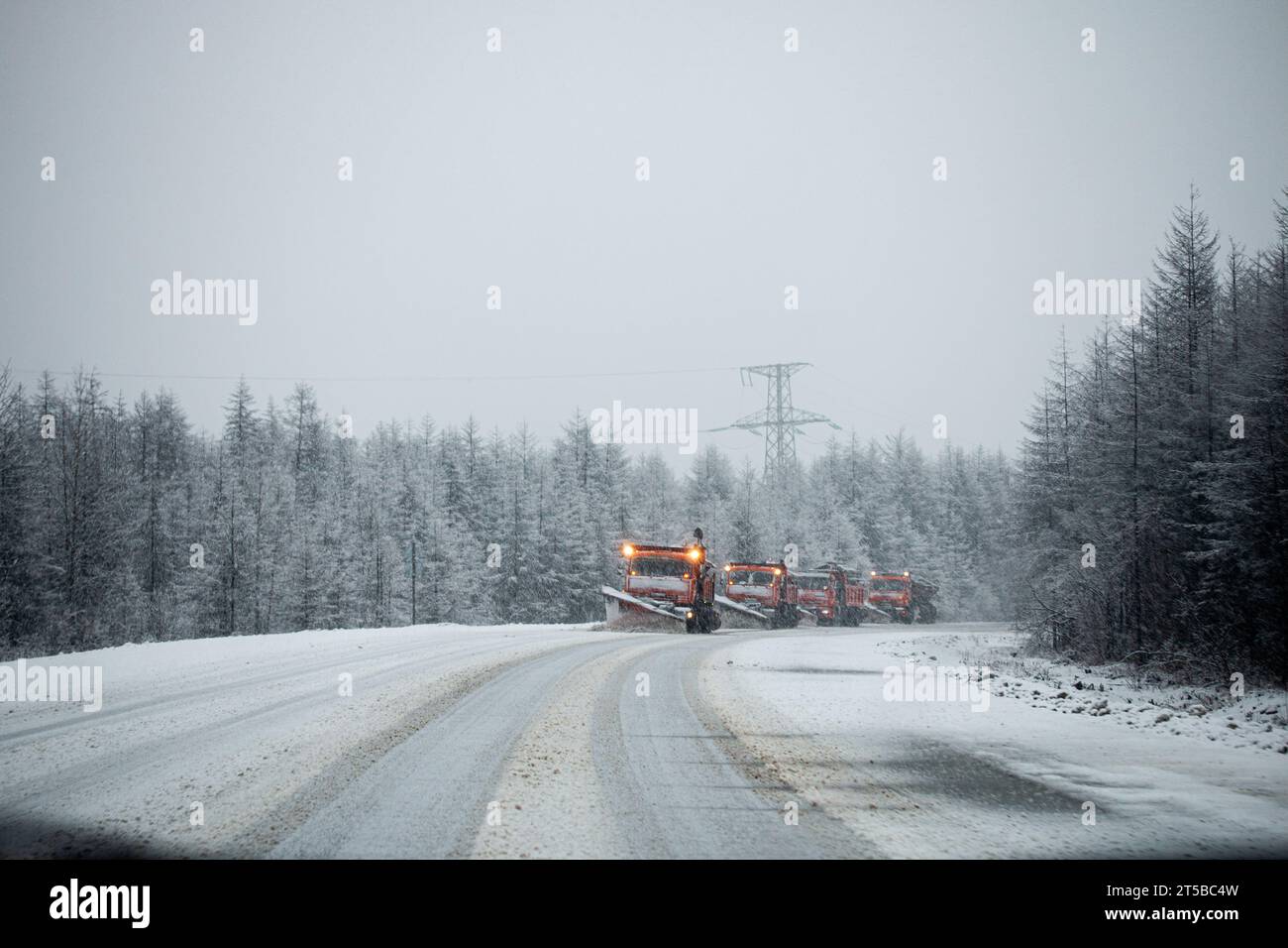 Winter service vehicles cleaning road with snowplows during the ...