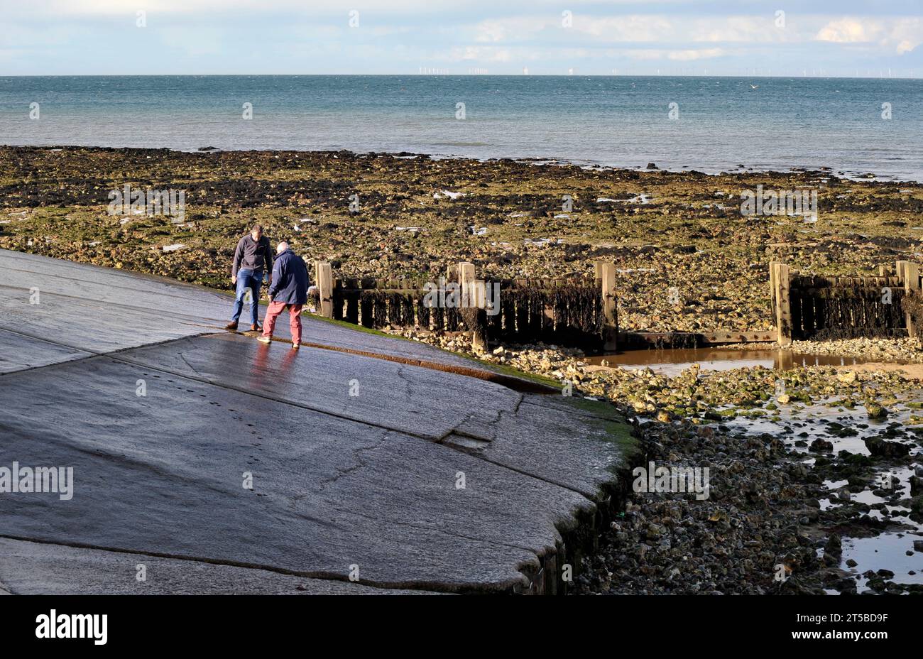 two men examining launching ramp at low tide west runton norfolk ...
