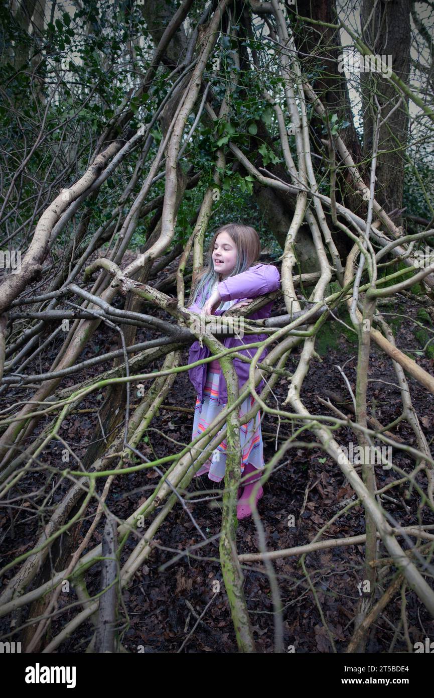small girl in woodland branch den wheathampstead hertfordshire england ...