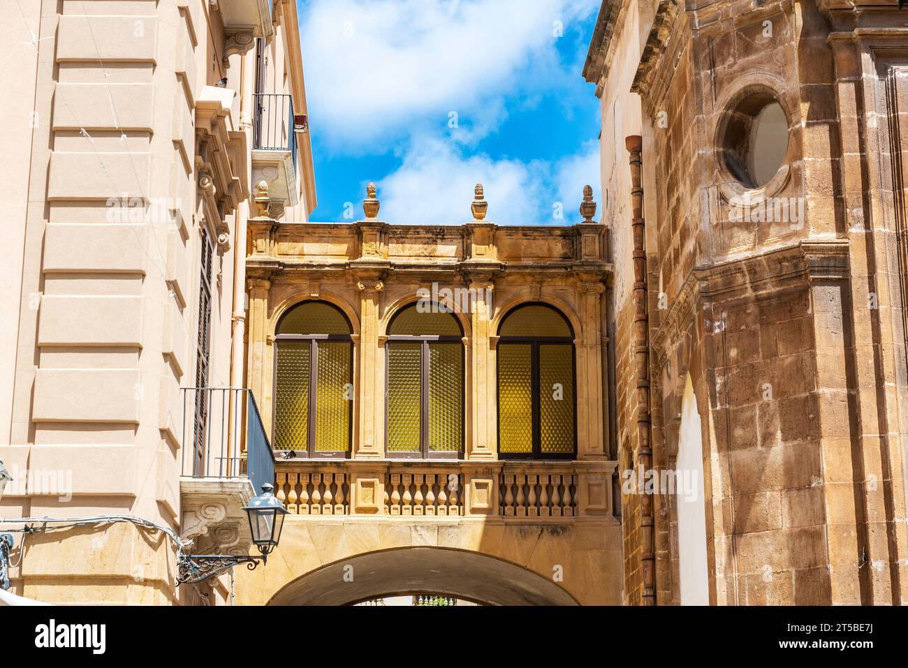 Street of classic buildings with an elevated exterior walkway ...