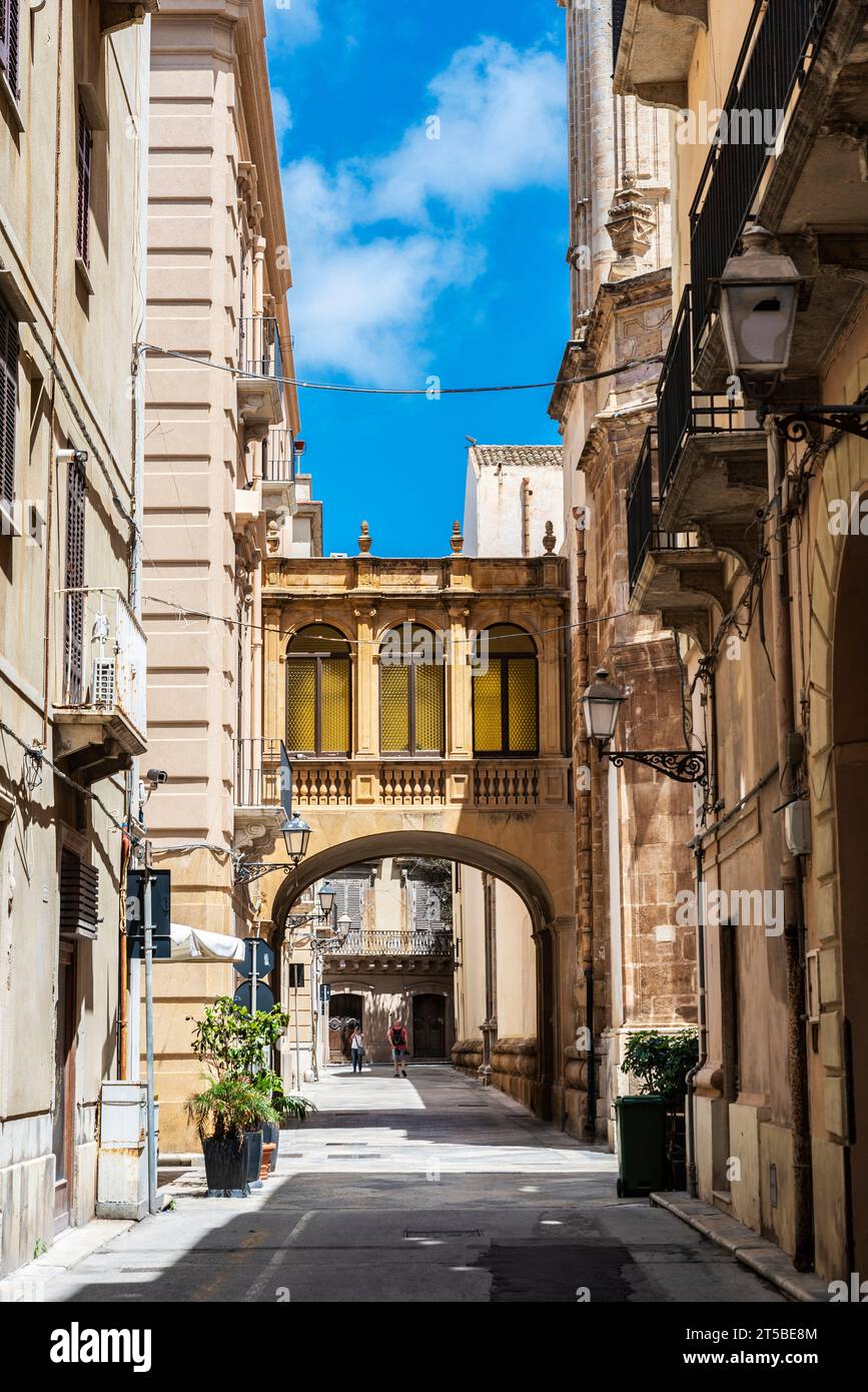 Street of classic buildings with an elevated exterior walkway ...