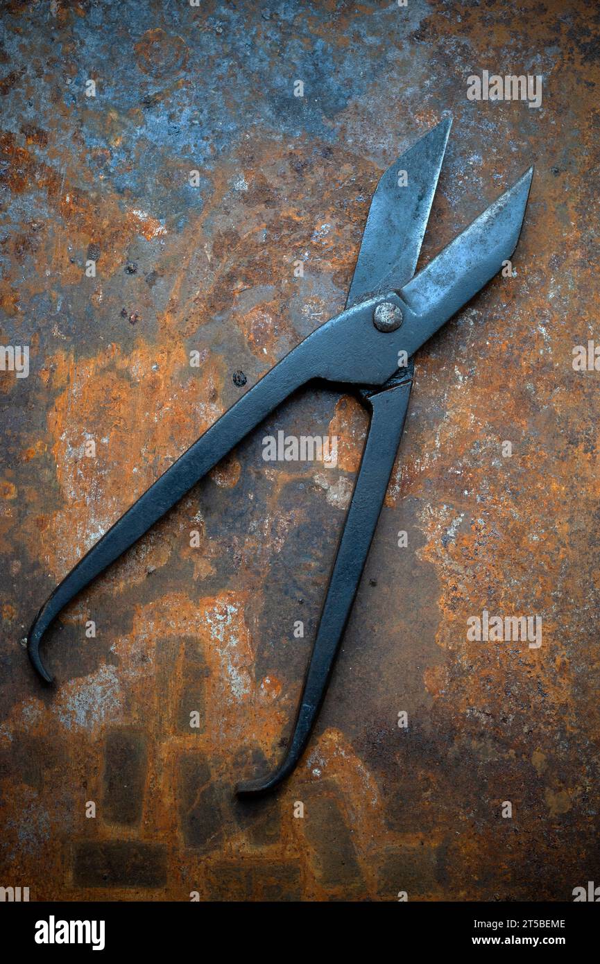 set of engineers metal tin shears laying on rusty metal surface Stock ...