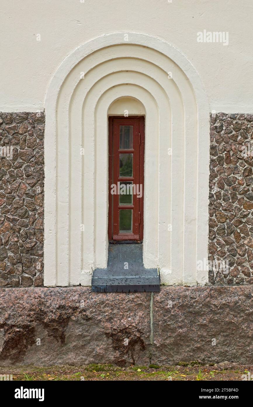 Red framed window with decorative arch on old stone wall Stock Photo ...