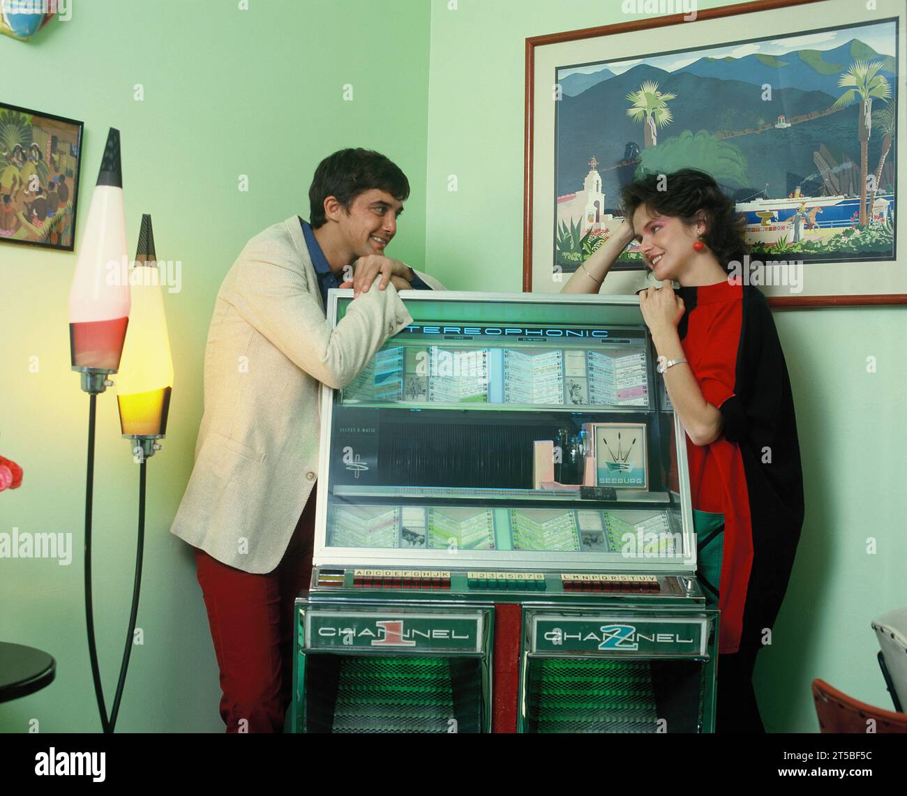 Young couple standing by classic vintage jukebox Stock Photo - Alamy