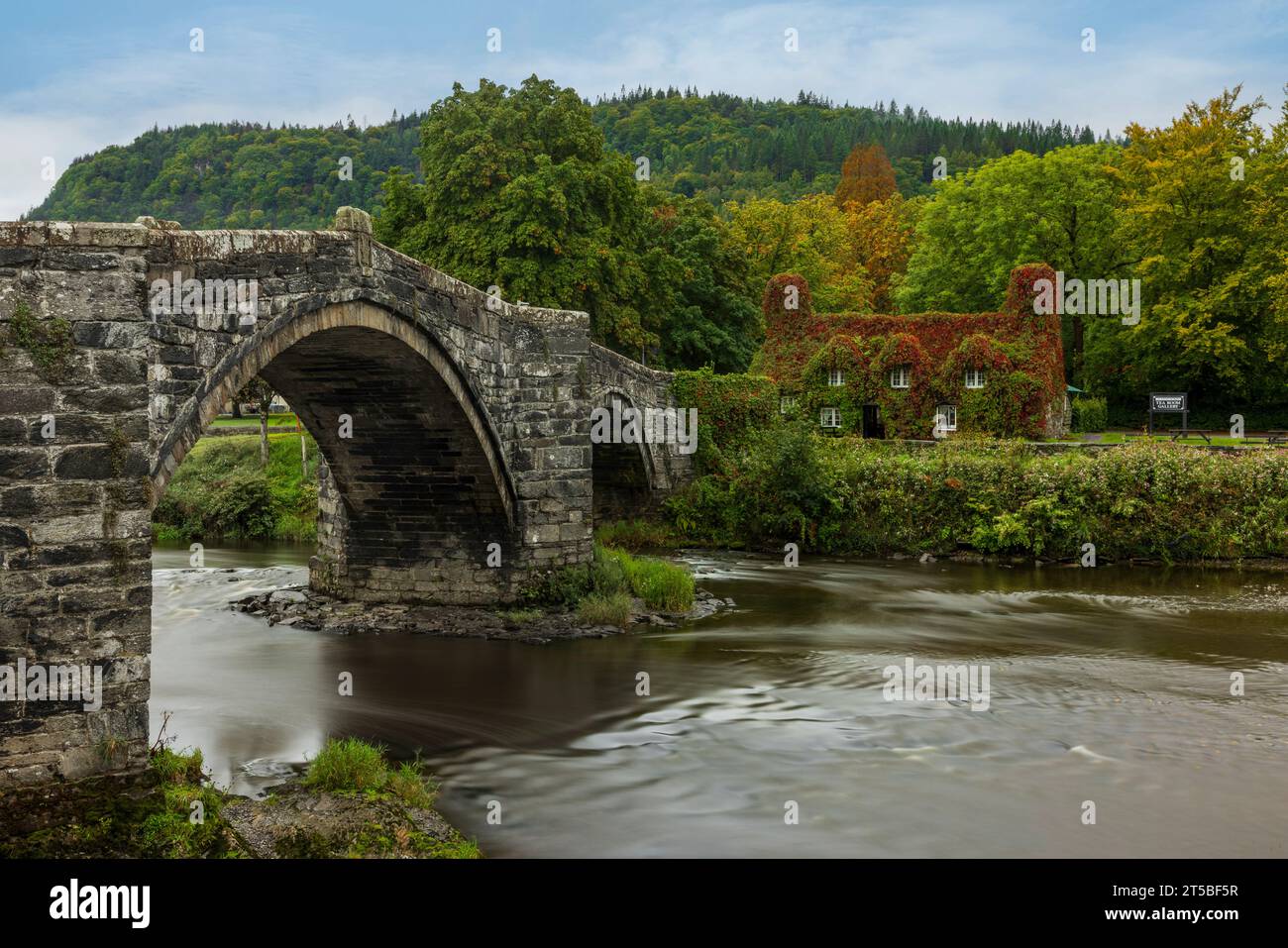 The historic Pont Fawr bridge and the Tu Hwnt I'r Bont Tearooms in ...